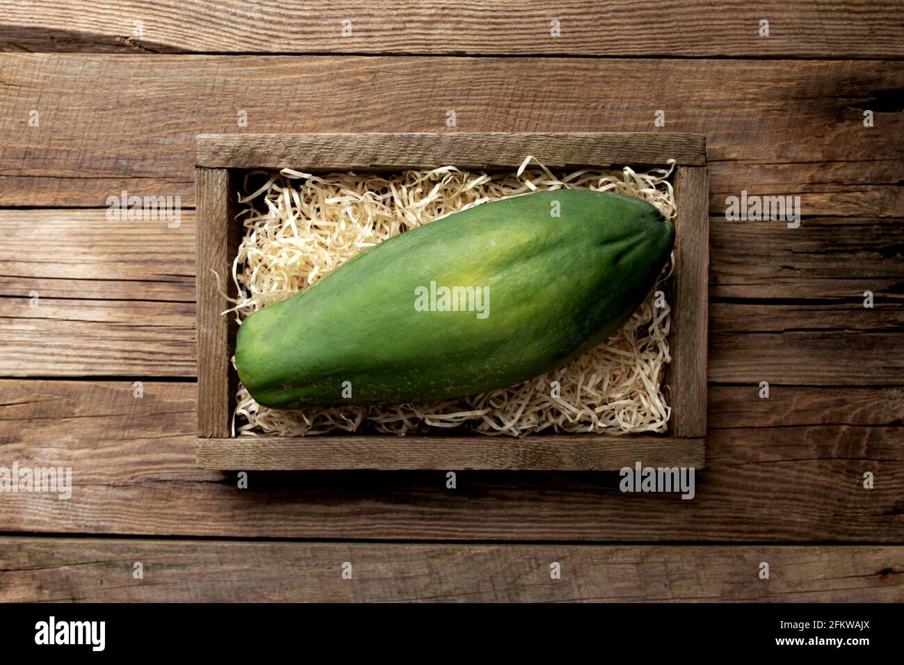 Fresh tropical papaya fruit in a wooden delivery box on a wooden ...