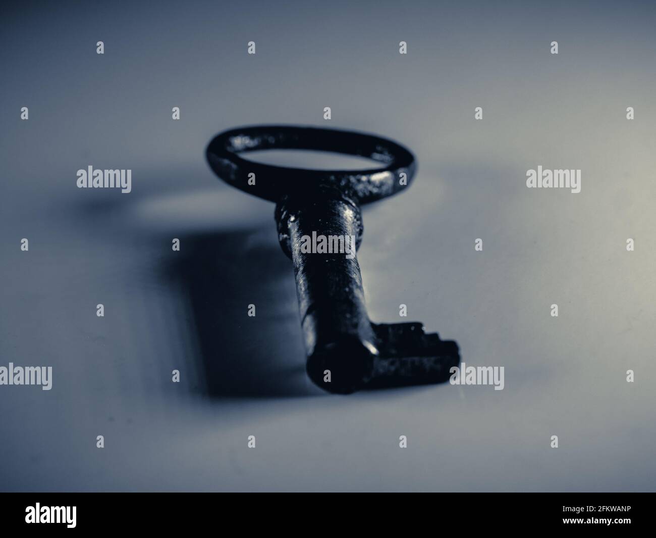 Grayscale photo of golden key isolated on white background. Old rusty ...