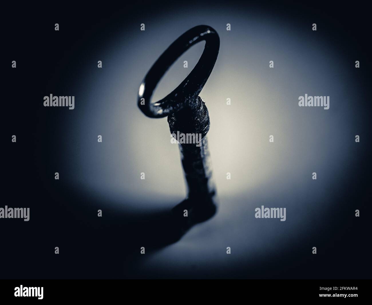 Grayscale photo of golden key isolated on white background. Old rusty ...