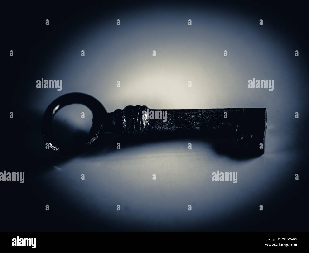 Grayscale photo of golden key isolated on white background. Old rusty ...