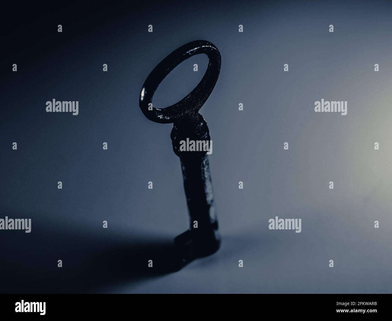 Grayscale photo of golden key isolated on white background. Old rusty ...