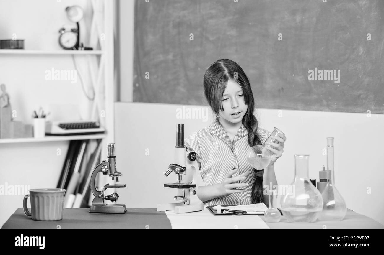 Scientific experiment. small girl with lab flask. back to school ...