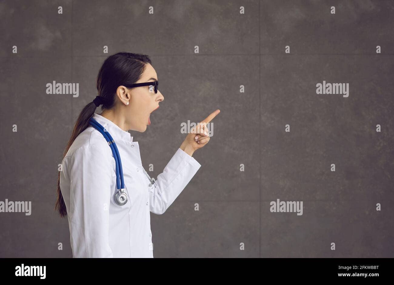 Shocked young caucasian doctor amazed facial expression studio shot ...