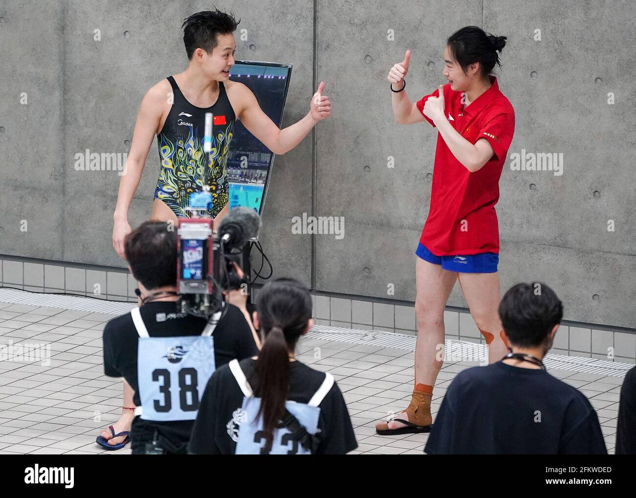 Tokyo. 4th May, 2021. Chen Yiwen (top L) and Chang Yani greet each other after the women's 3m ...