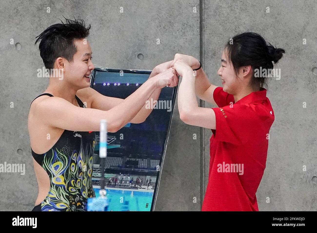 Tokyo. 4th May, 2021. Chen Yiwen (L) and Chang Yani greet each other after the women's 3m ...