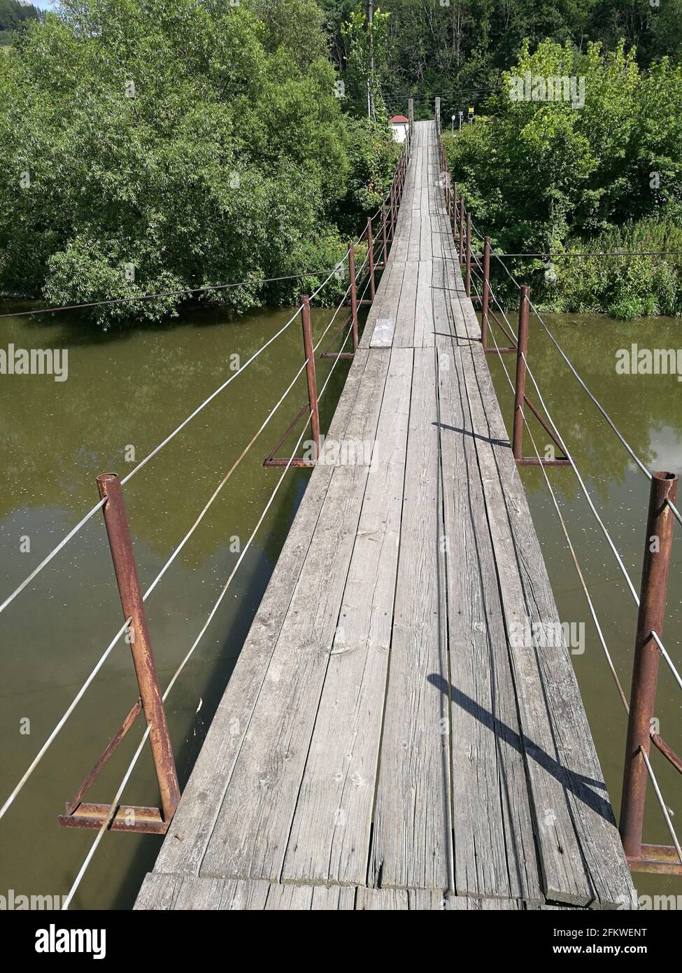 Old wooden bridge over a river Stock Photo - Alamy