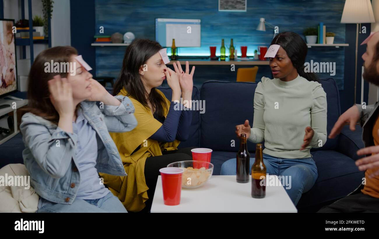 Group of multi-ethnic people having fun while playing board game using ...