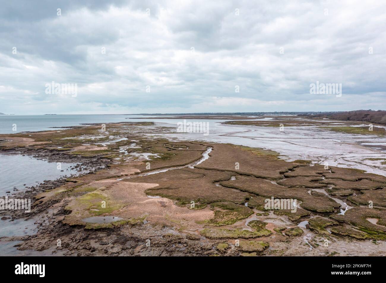 aerial view looking down an estury at the mouth of the sea showing ...