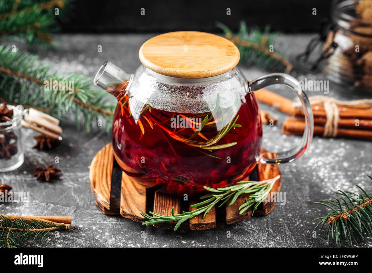 Glass kettle of fresh berry tea with rosemary Stock Photo - Alamy