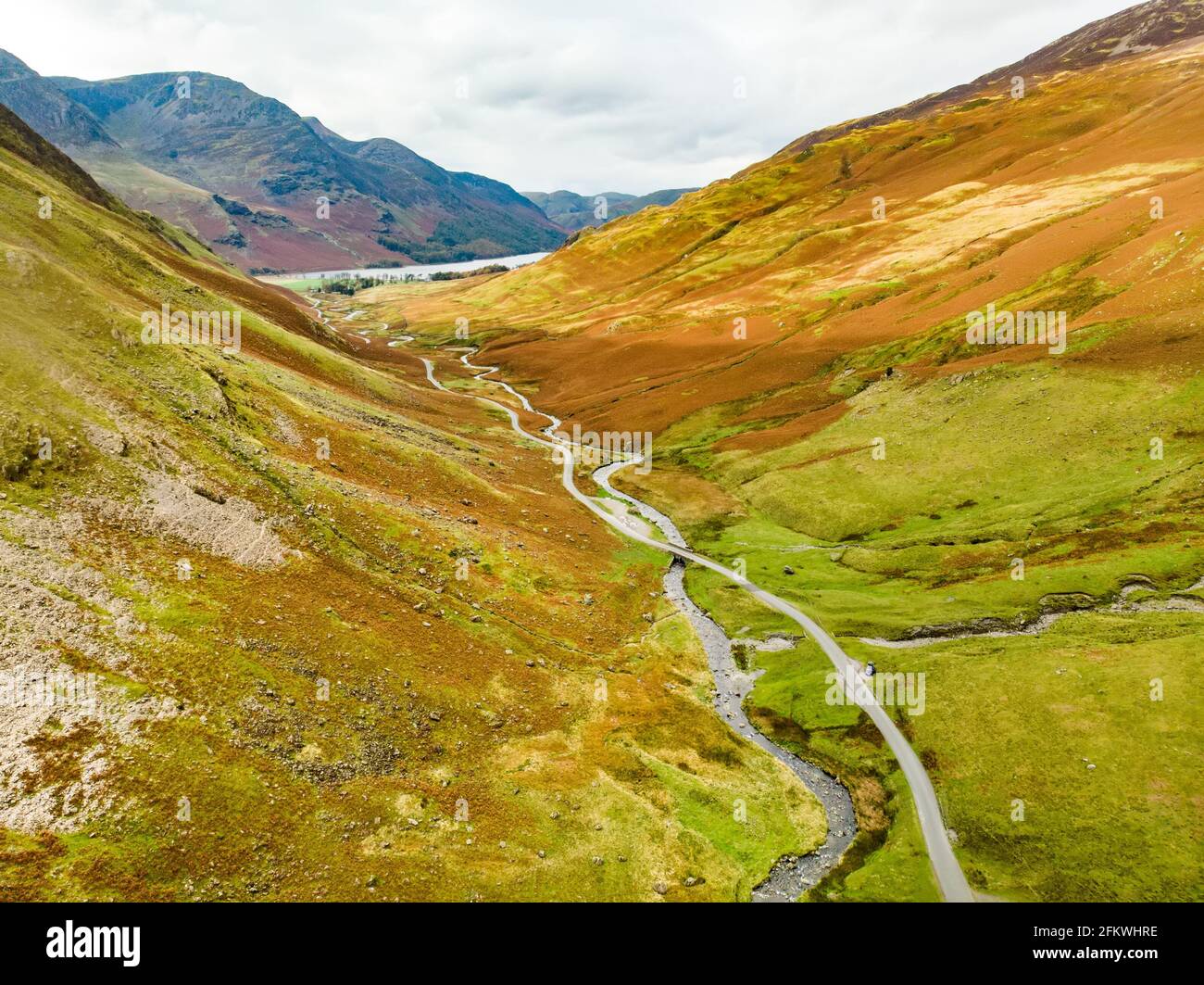 Aerial view of Honister Pass, a mountain pass with a road winding along ...