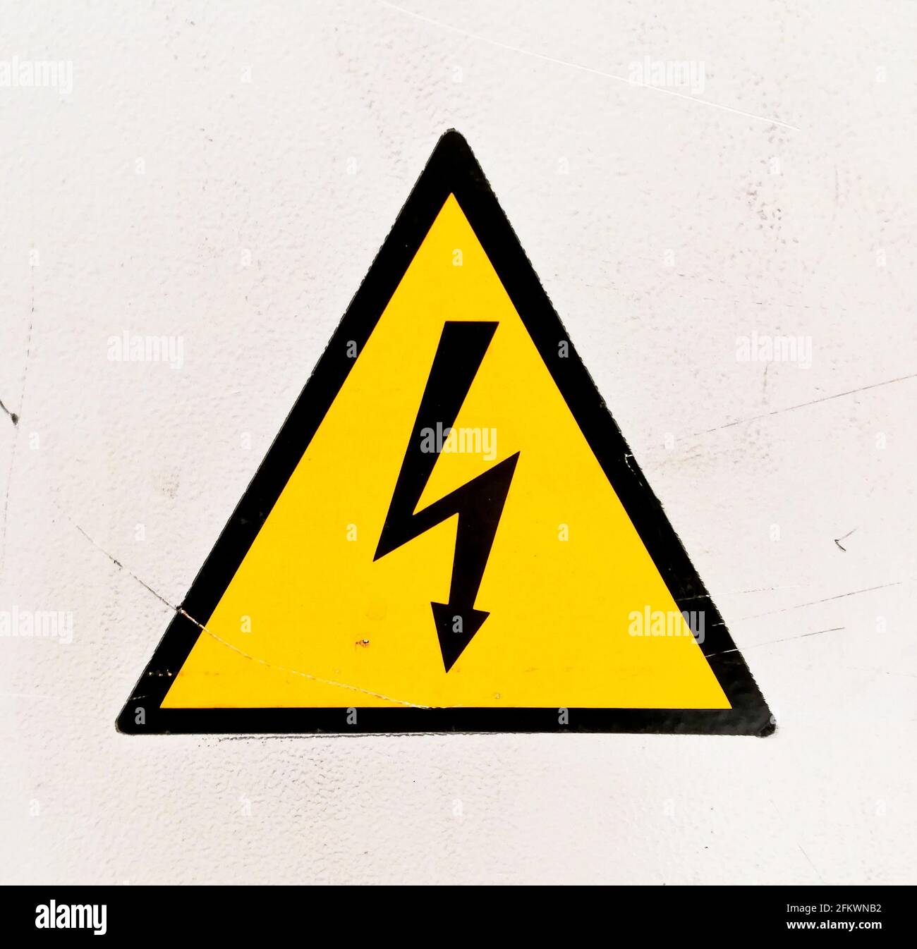 Yellow and black high voltage warning sign on white background Stock ...