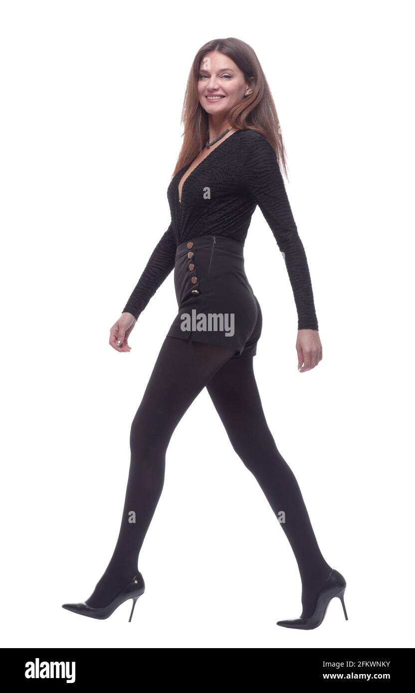 in full growth. beautiful young woman confidently striding forward ...