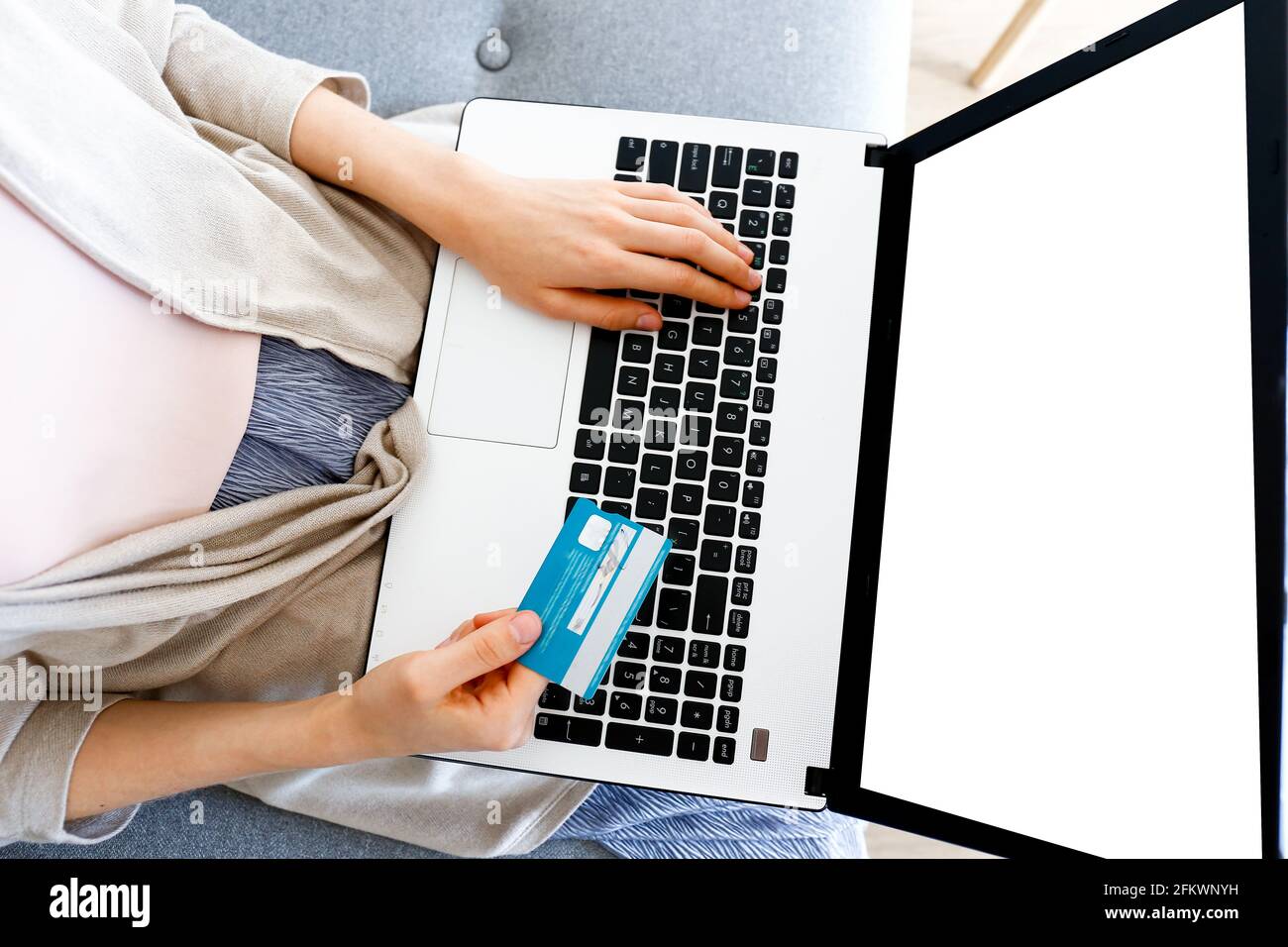 Slim woman holding credit card in hands and using her computer. Female ...