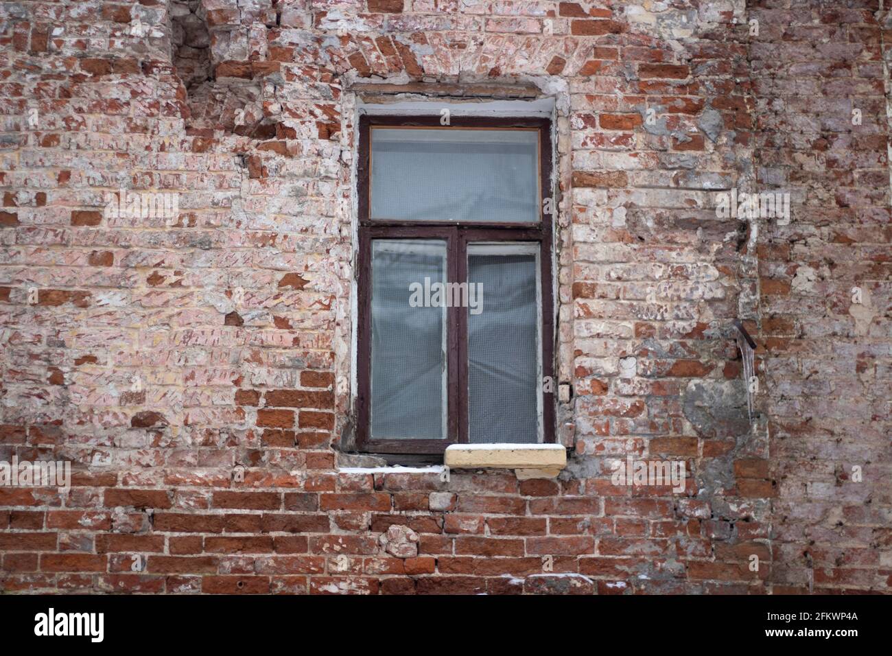 A window in a brick wall. Destroyed wall in an old building ...