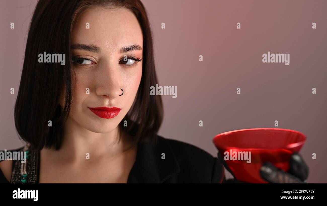 Beautiful girl with a red glass Stock Photo - Alamy