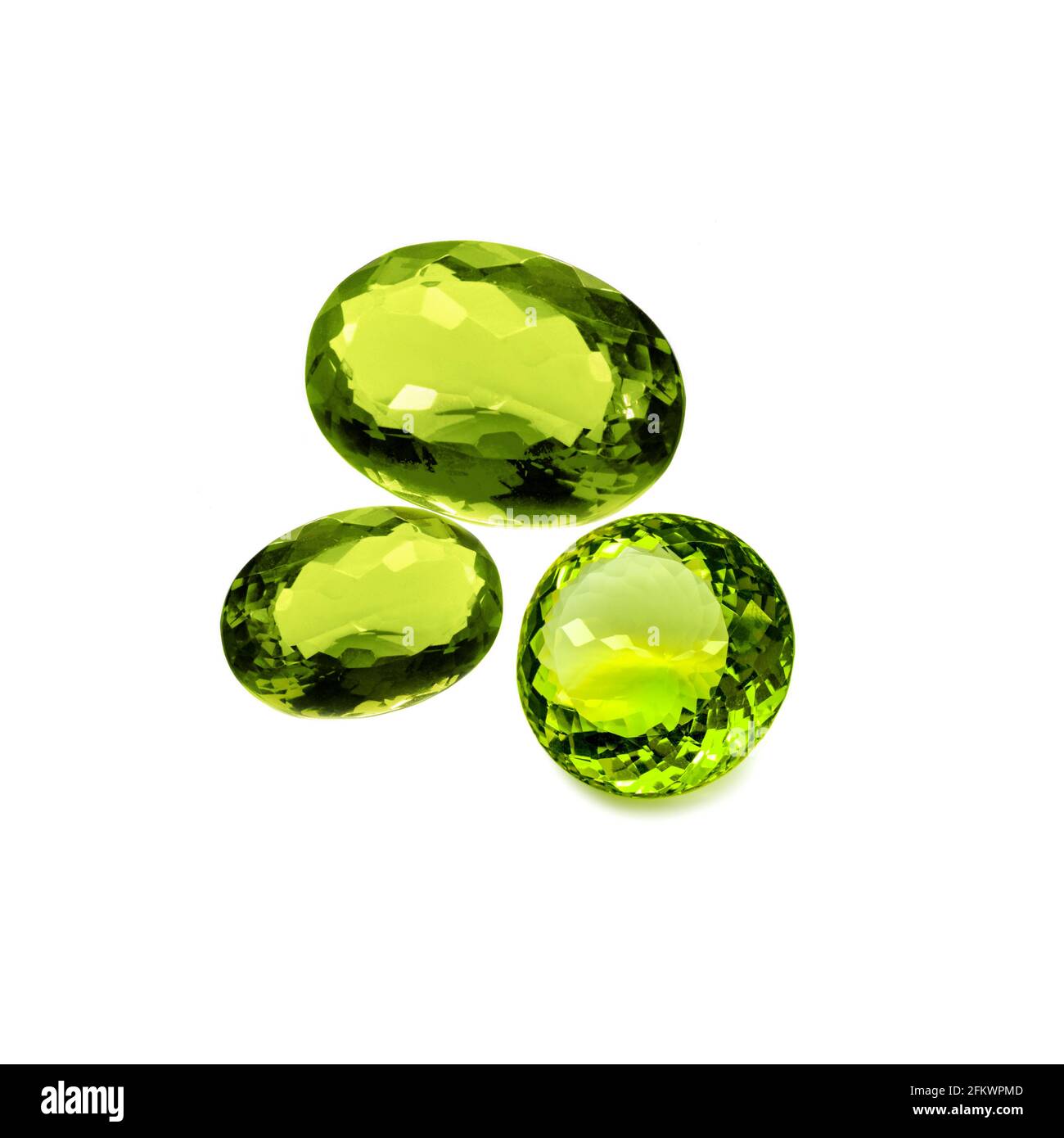 Three peridot or chrysolite gems on a white background Stock Photo - Alamy