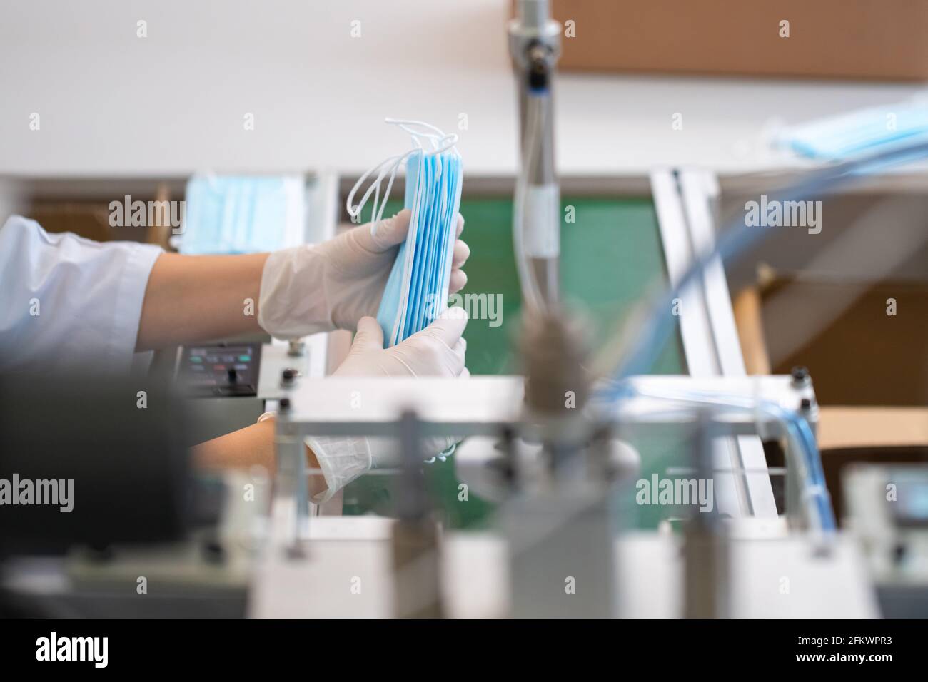 Factory worker wearing gloves hi-res stock photography and images - Alamy