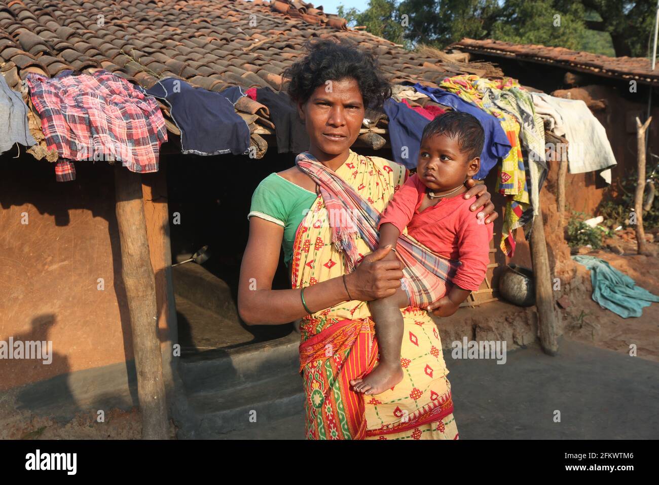 Mother and Child, DESIA KONDHA TRIBE. Standing outside house. Odisha ...