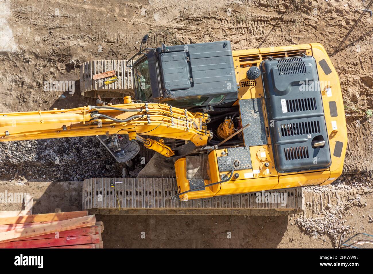 Excavator on the ground of a construction site with a raised bucket ...