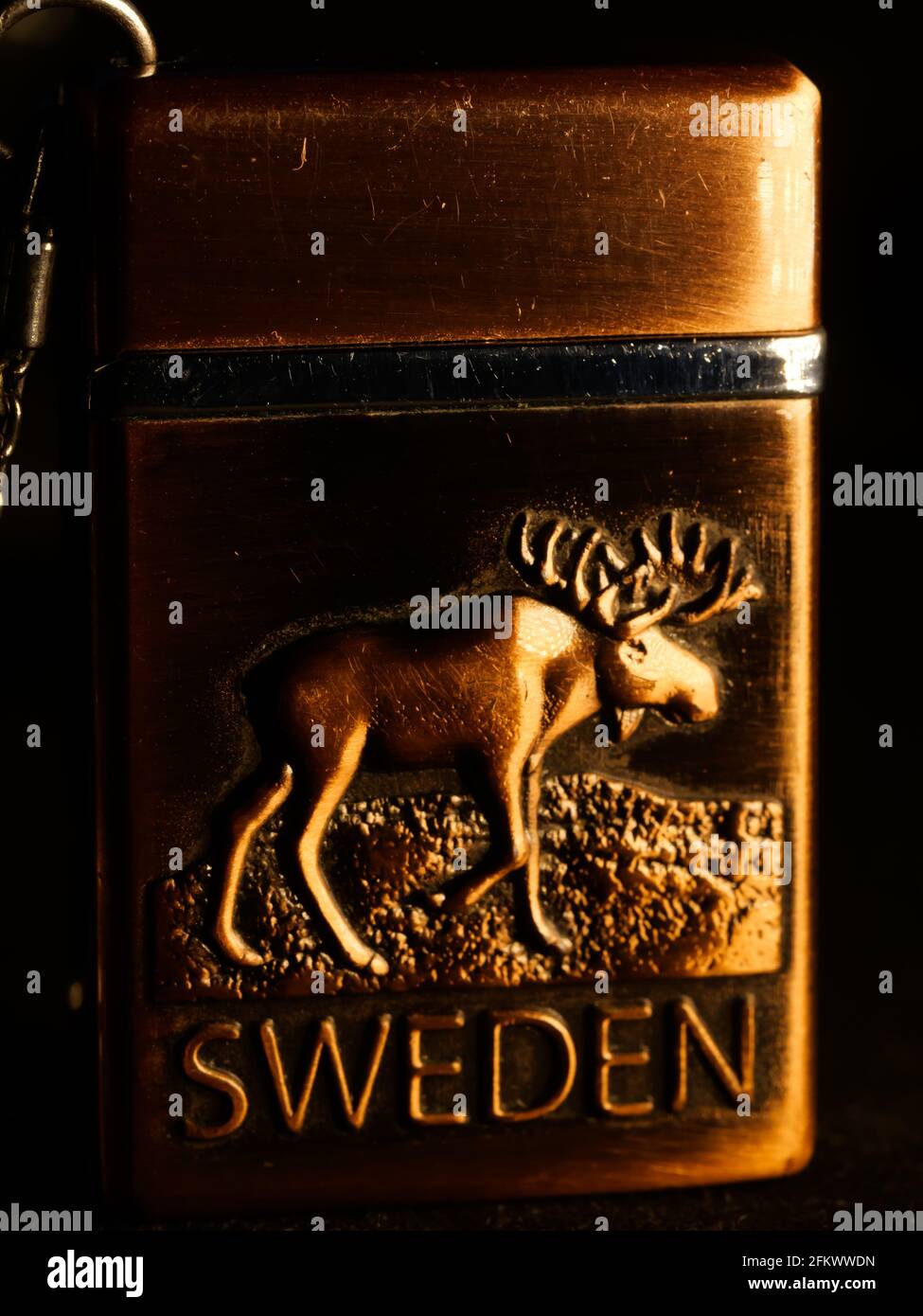 Vertical shot of a lighter with a figure of a deer made by Sweden ...