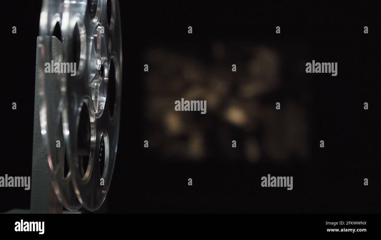 Photo of projector filming on black background Stock Photo - Alamy