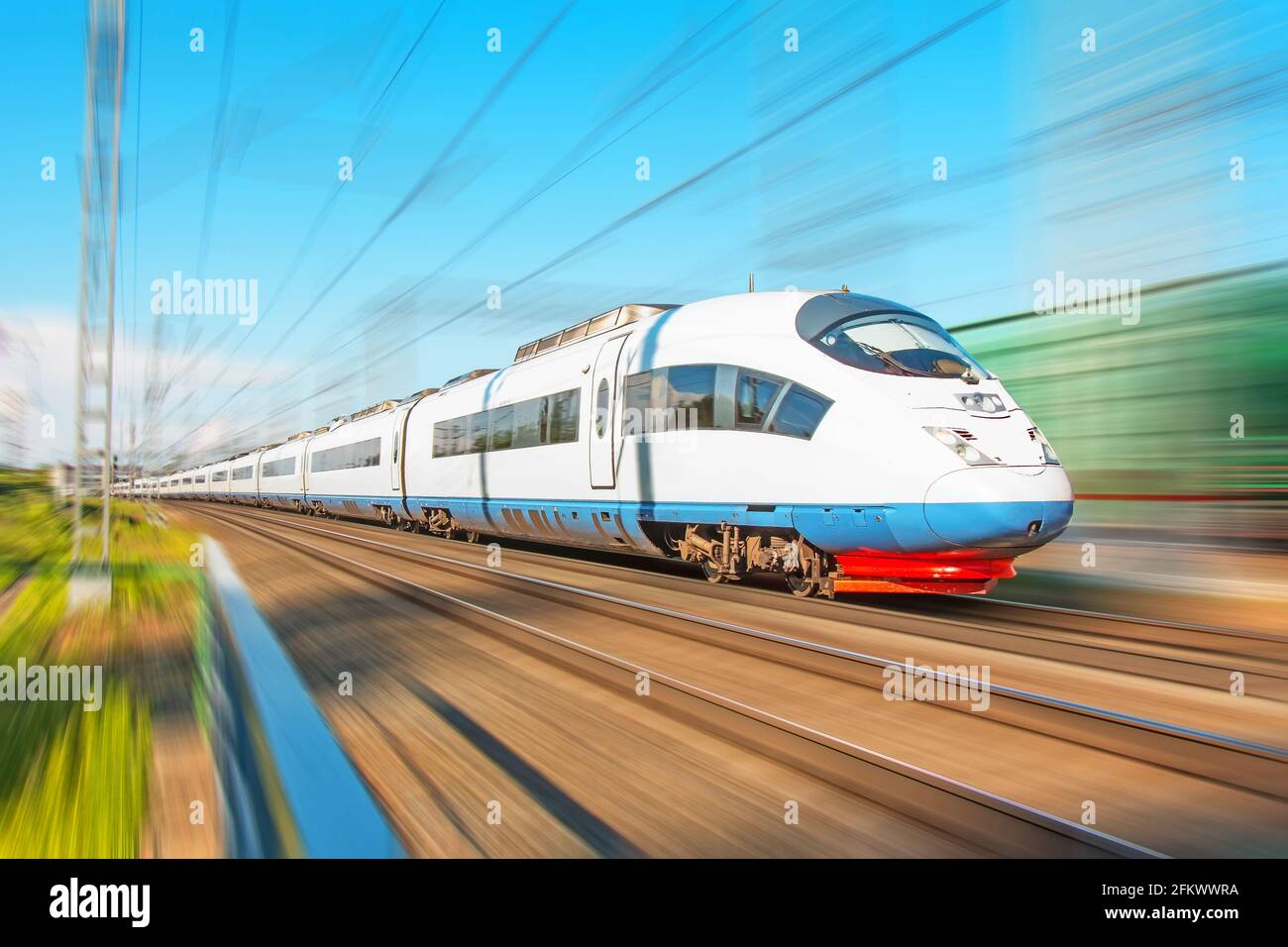 High speed train rides at high speed at the railway station in the city ...
