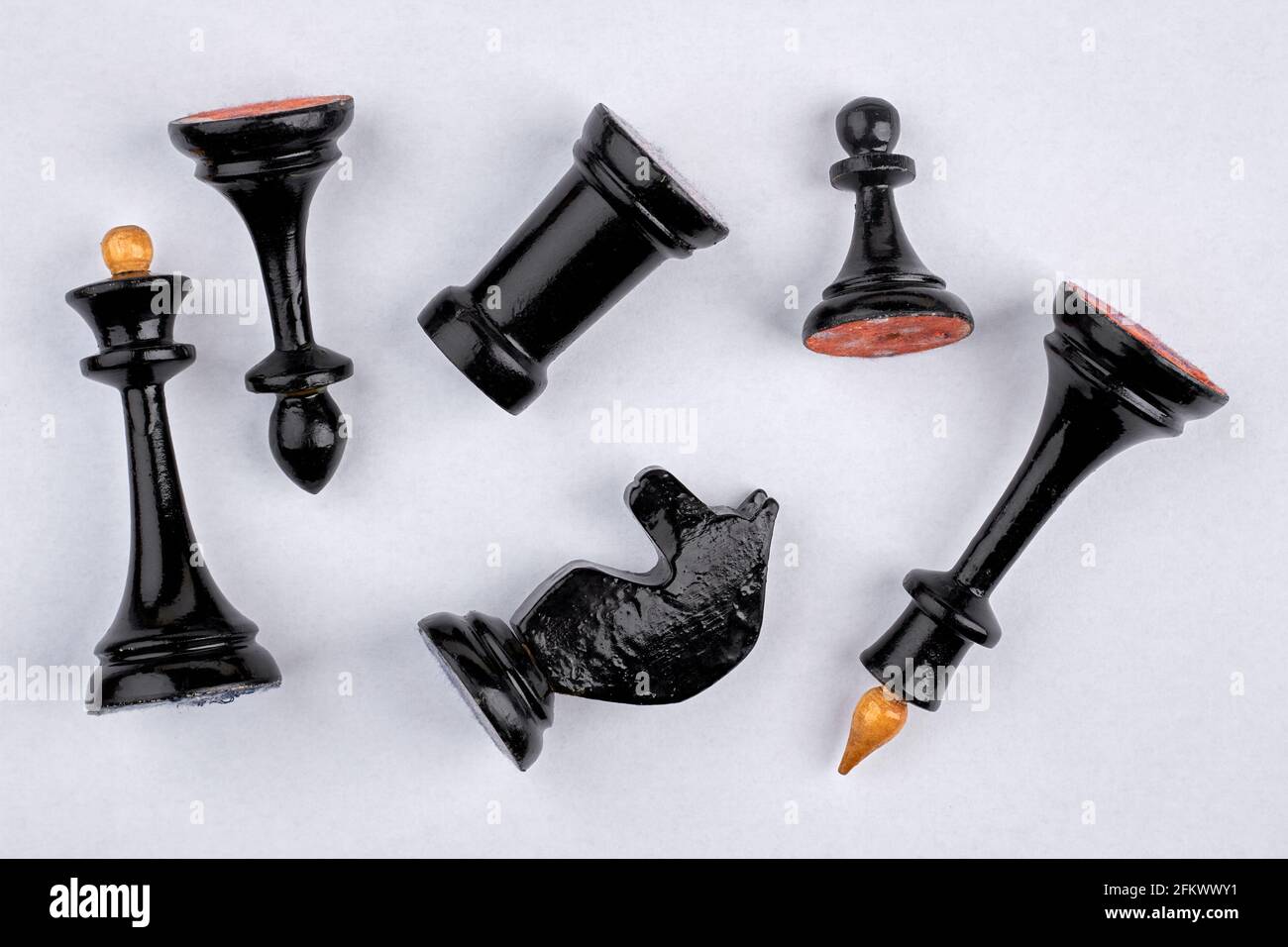 Top view of black chess pieces lying on white background Stock Photo ...
