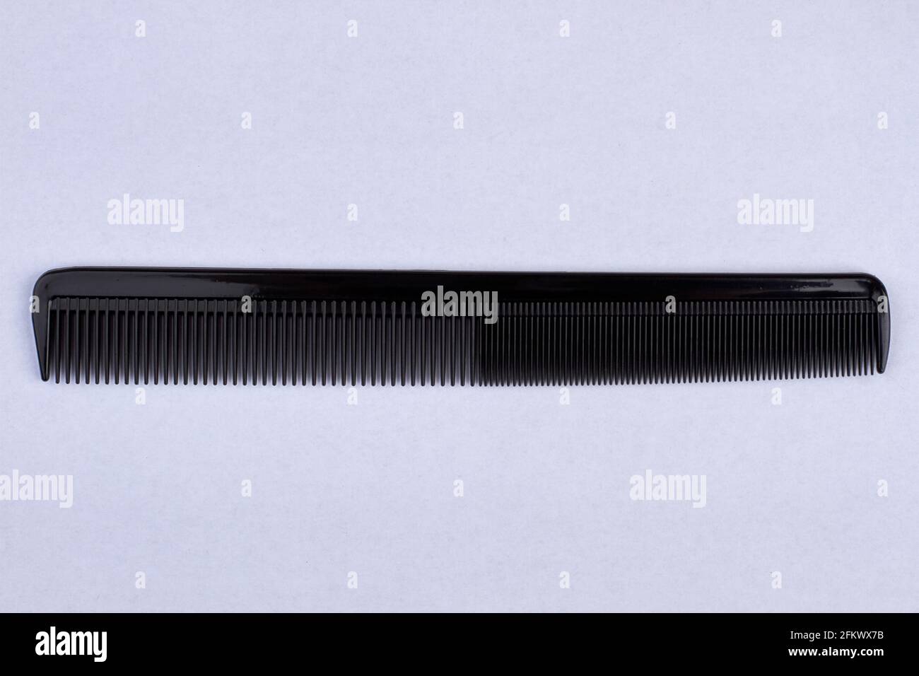 Black plastic comb isolated on white background Stock Photo - Alamy