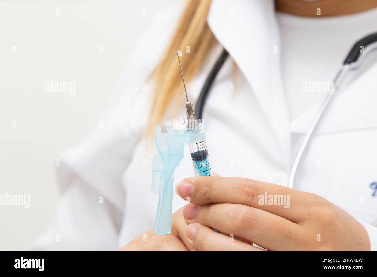 Asian girl holding syringe hi-res stock photography and images - Alamy
