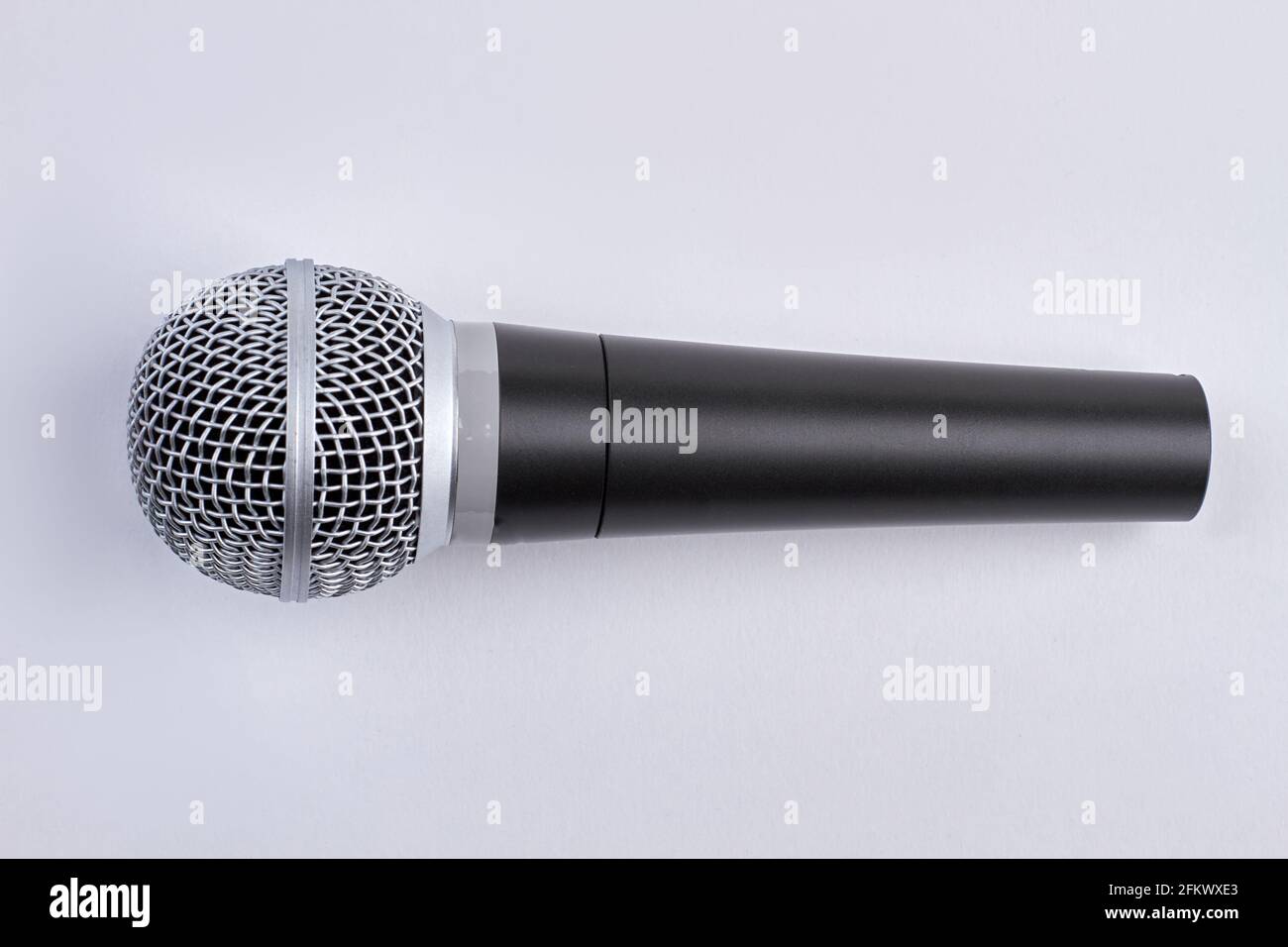 Close up of black and gray wireless microphone on white background ...