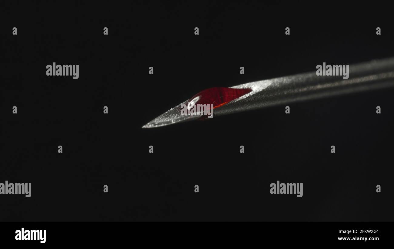 Photo of syringe needle with drop of red liquid Stock Photo - Alamy