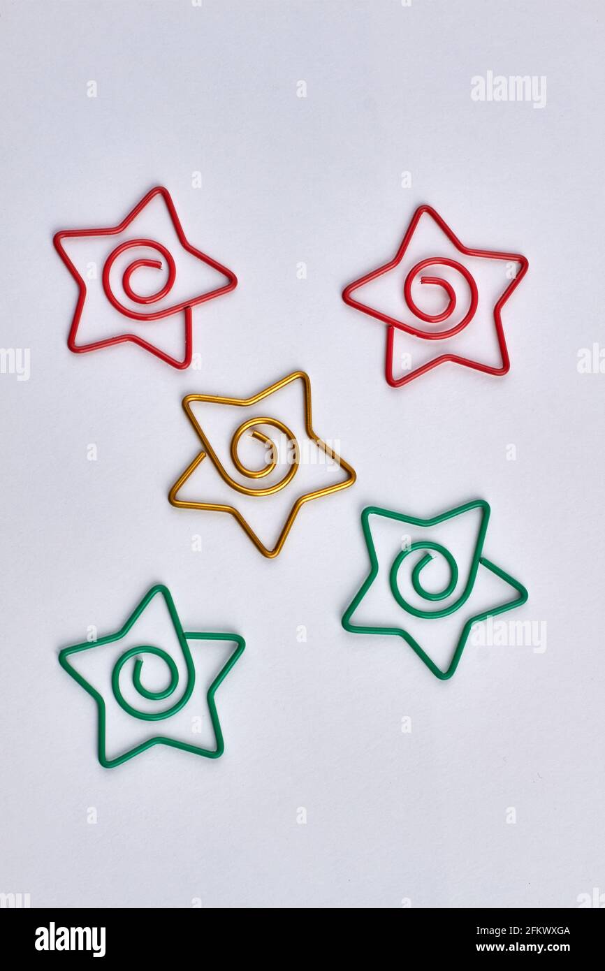 Top view of five-pointed star shaped paper clips on white background ...