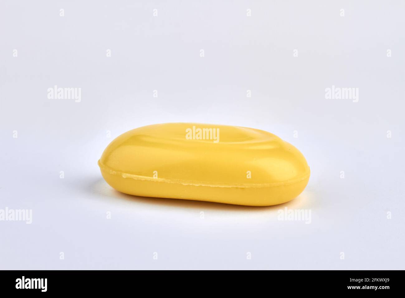 Bar of yellow soap isolated on white background Stock Photo - Alamy