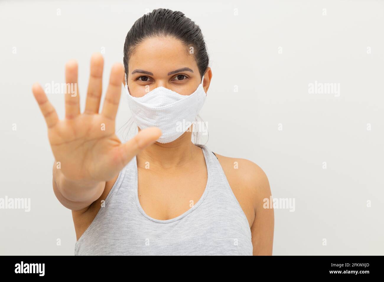 40-year-old woman in a mask with her hand extended forward. Focus on ...