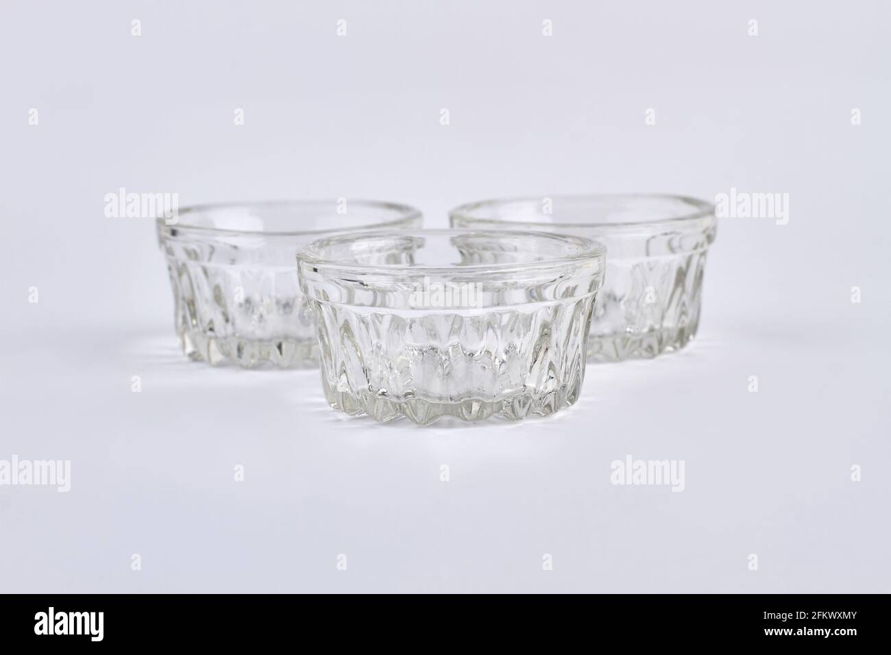 Three empty glass bowls isolated on white background Stock Photo - Alamy
