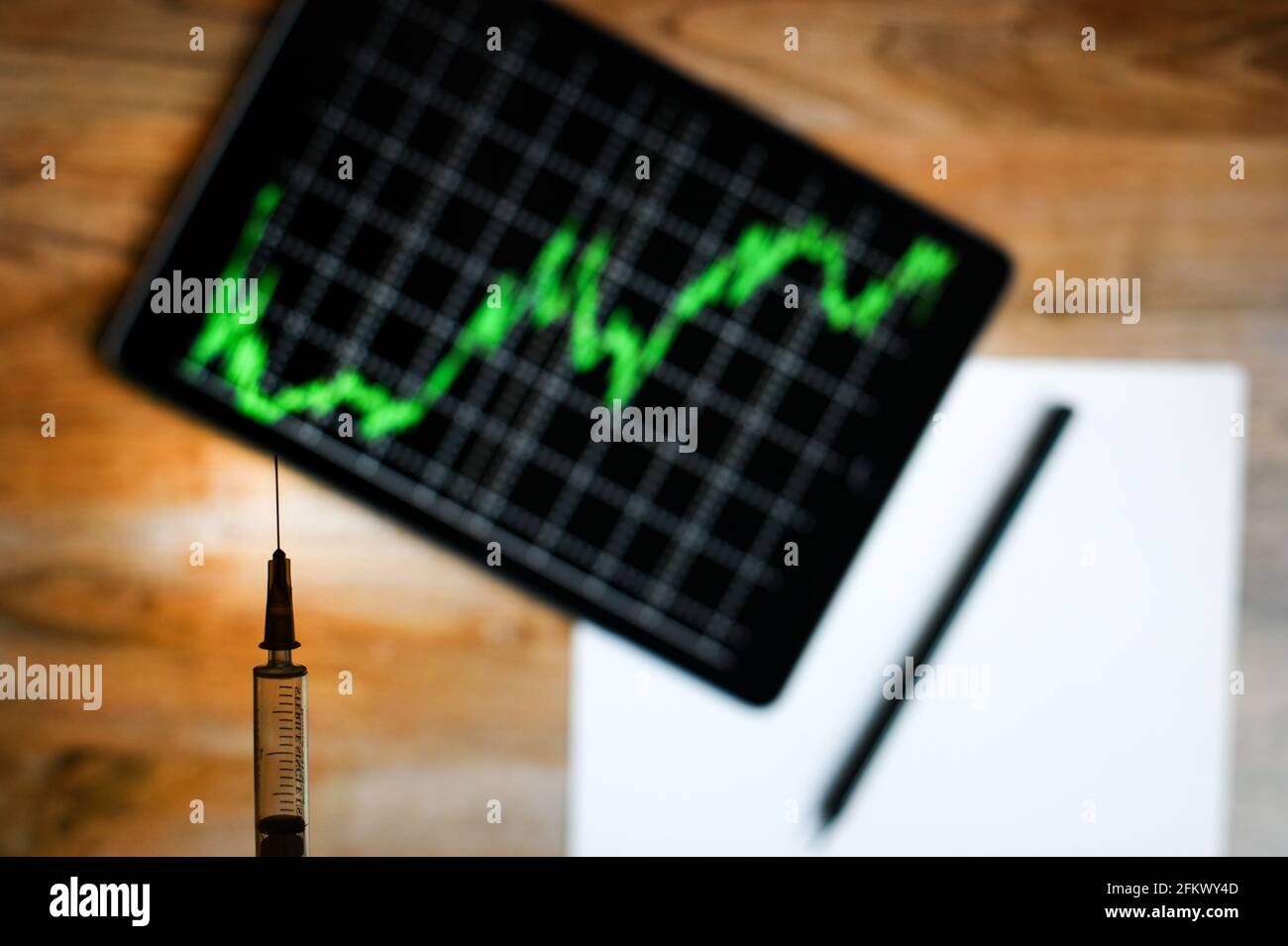 In this photo illustration a medical syringe is seen in front of a ...