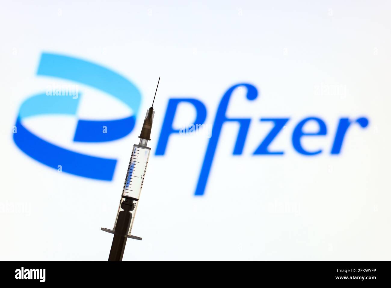 Poland. 02nd May, 2021. In this photo illustration a medical syringe is seen in front of a logo ...