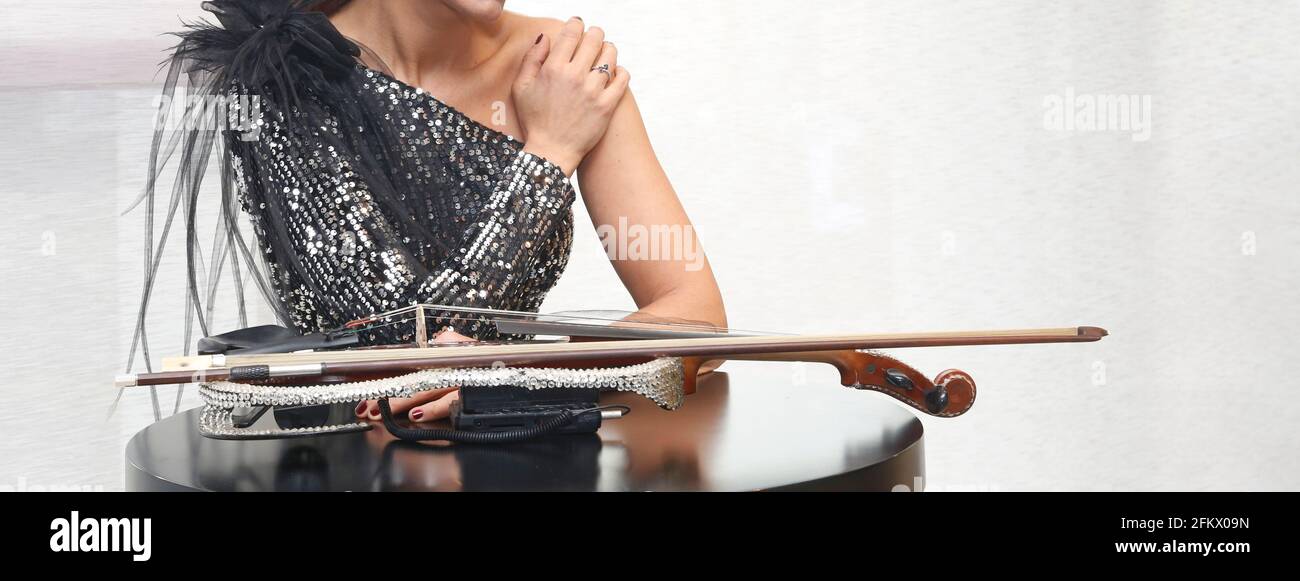 female violin performer and her violin standing on the table Stock ...