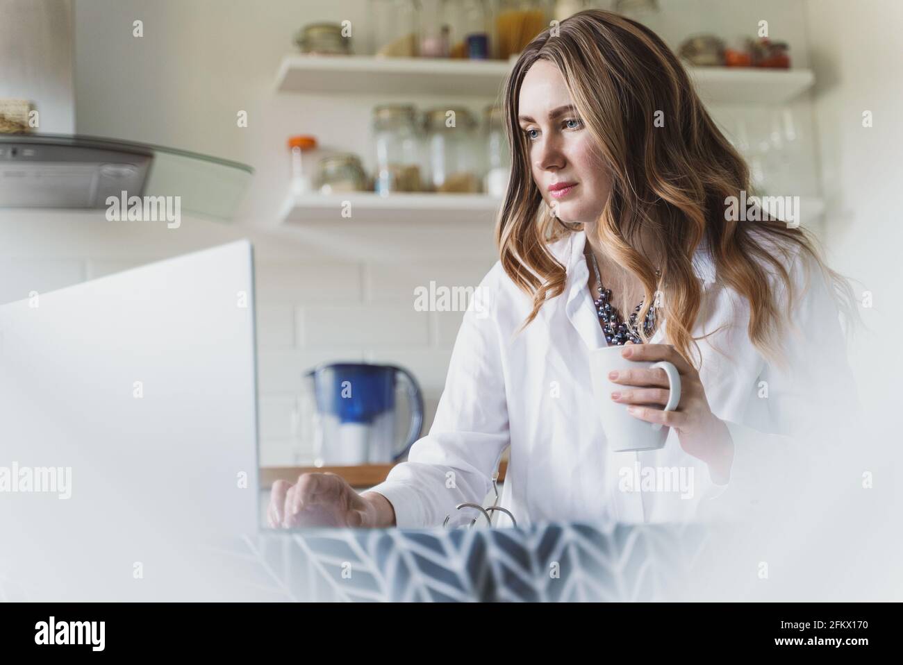 Woman works in the kitchen at home. Self isolation concept Stock Photo ...