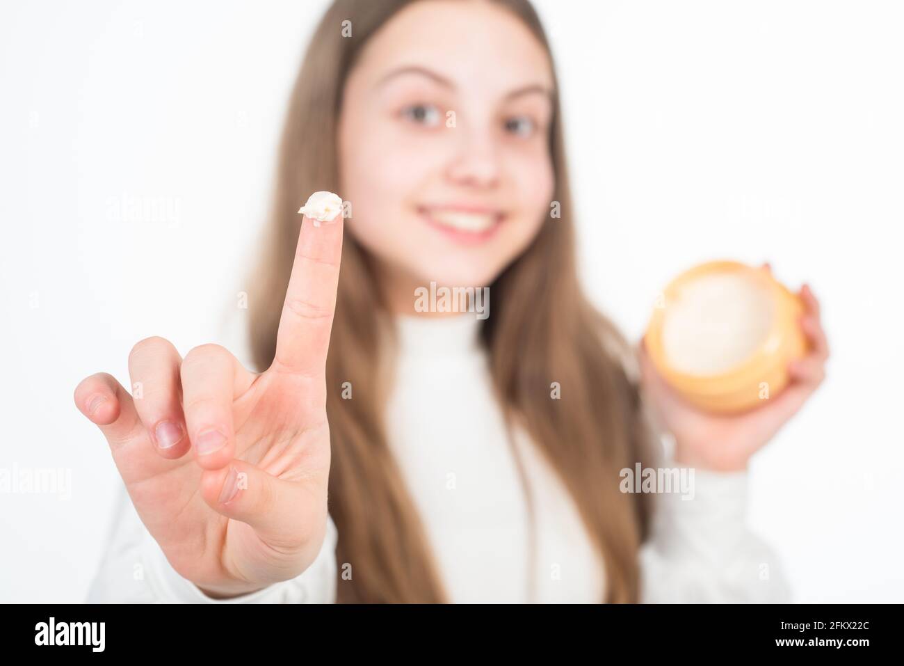 cream on finger of kid. happy girl applying mask. child with skin cream ...