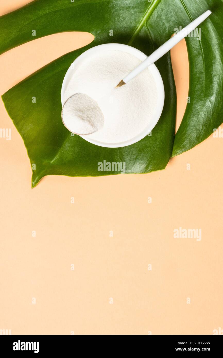 Collagen powder dietary supplement at pastel background Stock Photo - Alamy