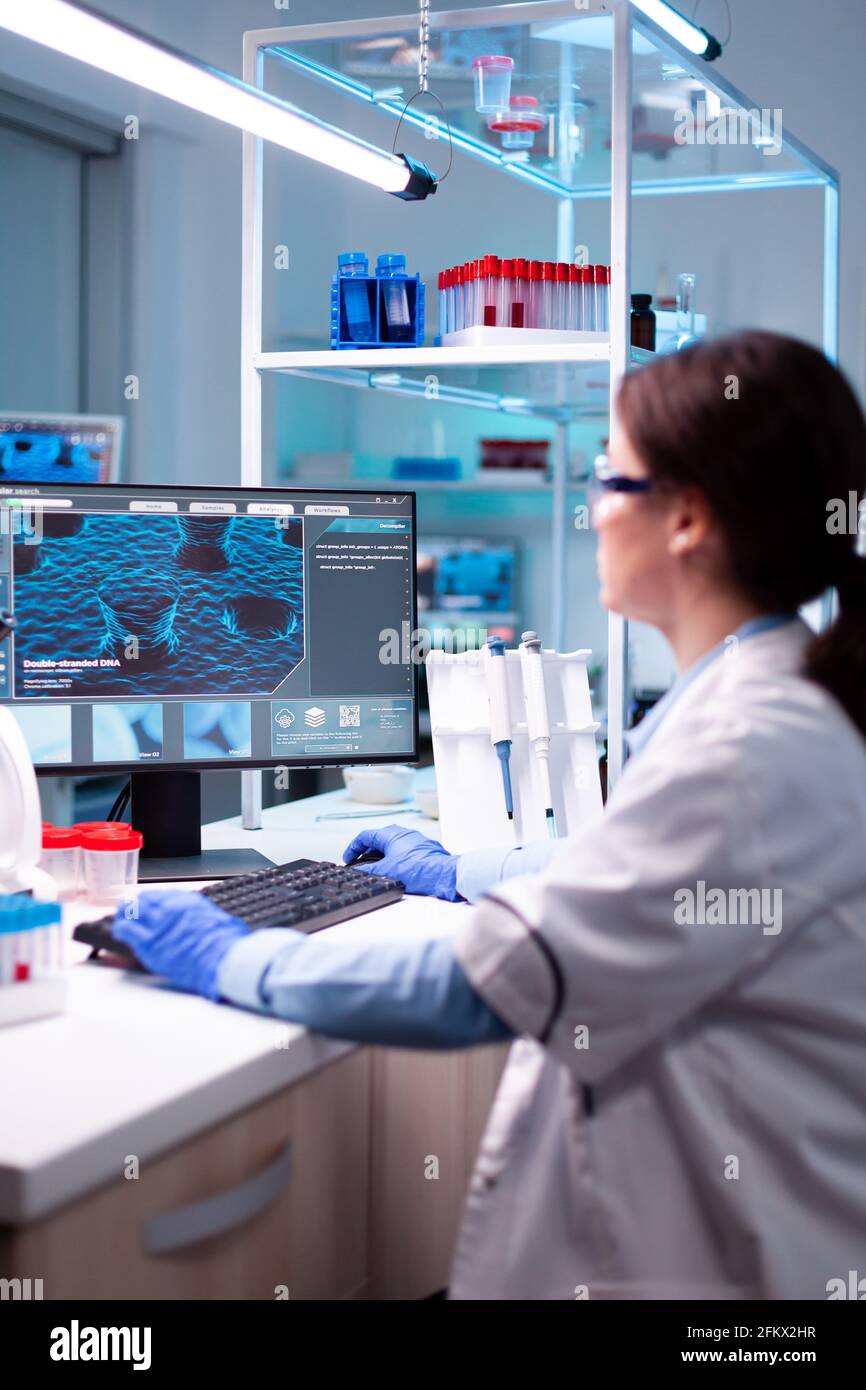 Woman scientist engineering virus in biochemistry laboratory ...