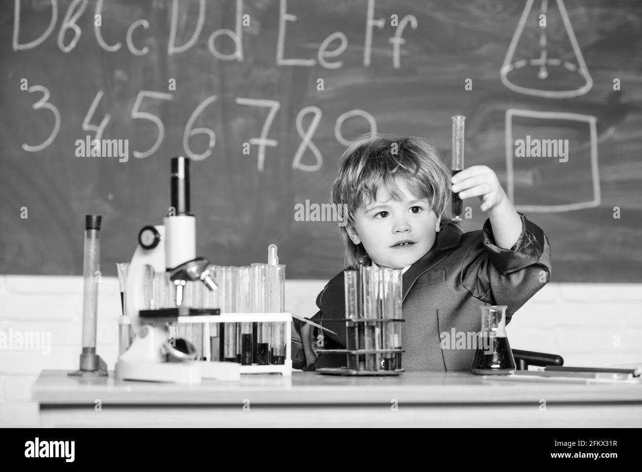 little boy at lesson. Back to school. science experiments with ...