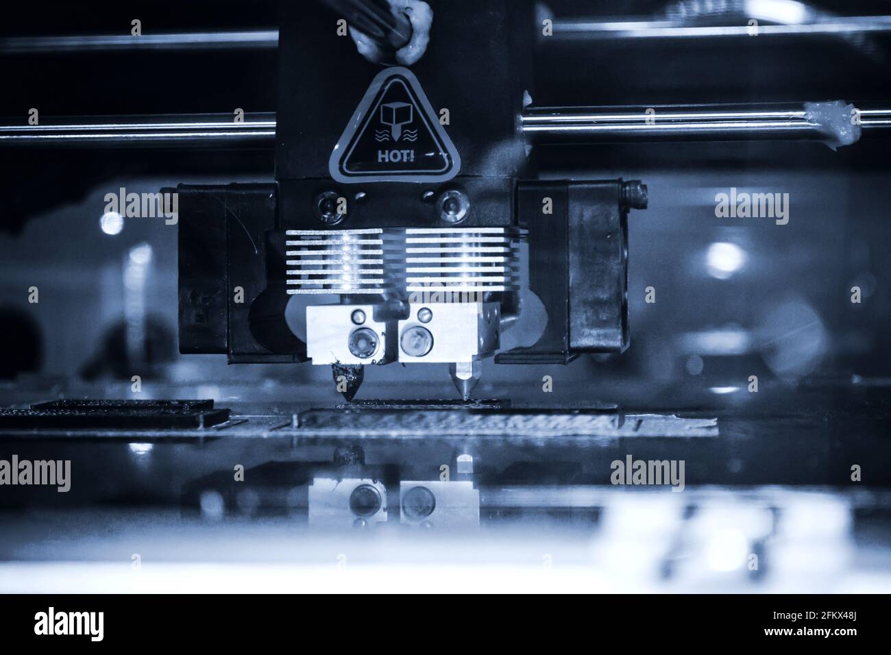 3D printer printing black shapes close-up Automatic three dimensional ...