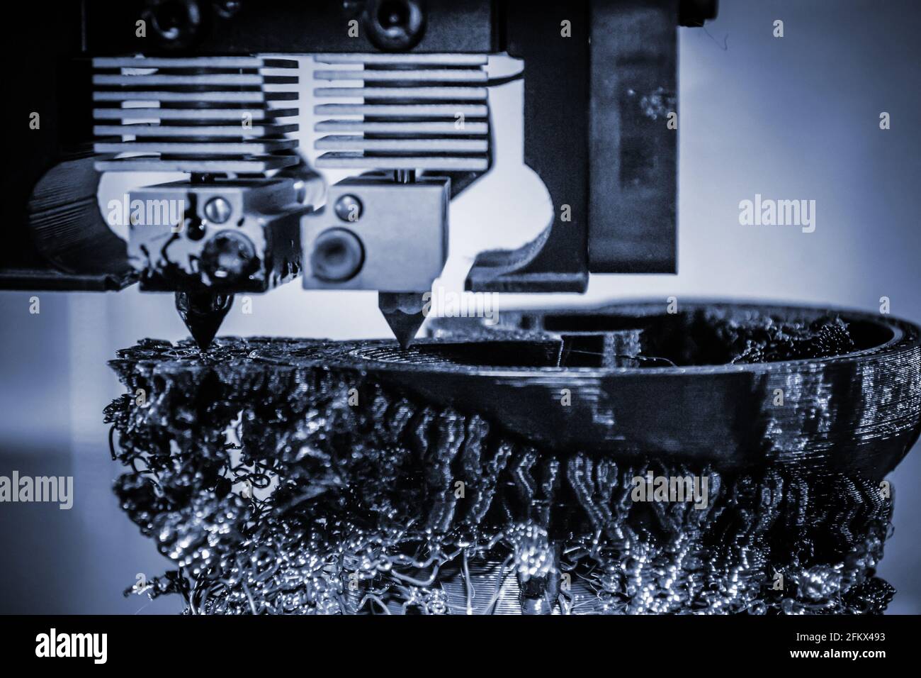 3D printer printing black shapes close-up Automatic three dimensional ...