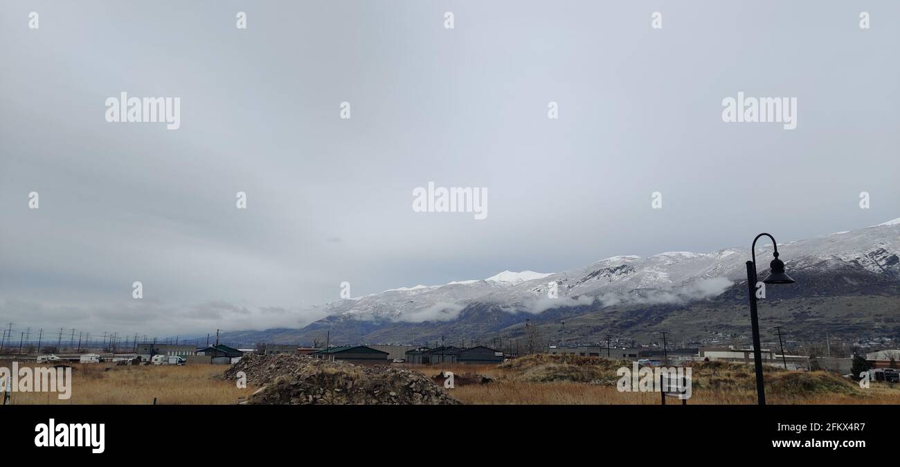 A beautiful snow-capped mountain range and dry fields on a gloomy cold day Stock Photo - Alamy