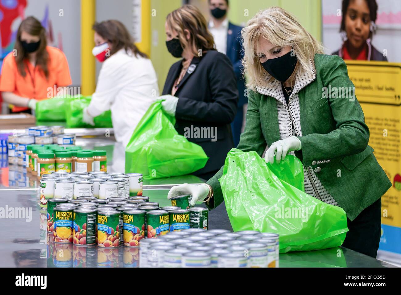First Lady Jill Biden Packs Canned Goods Into Bags For Children In The