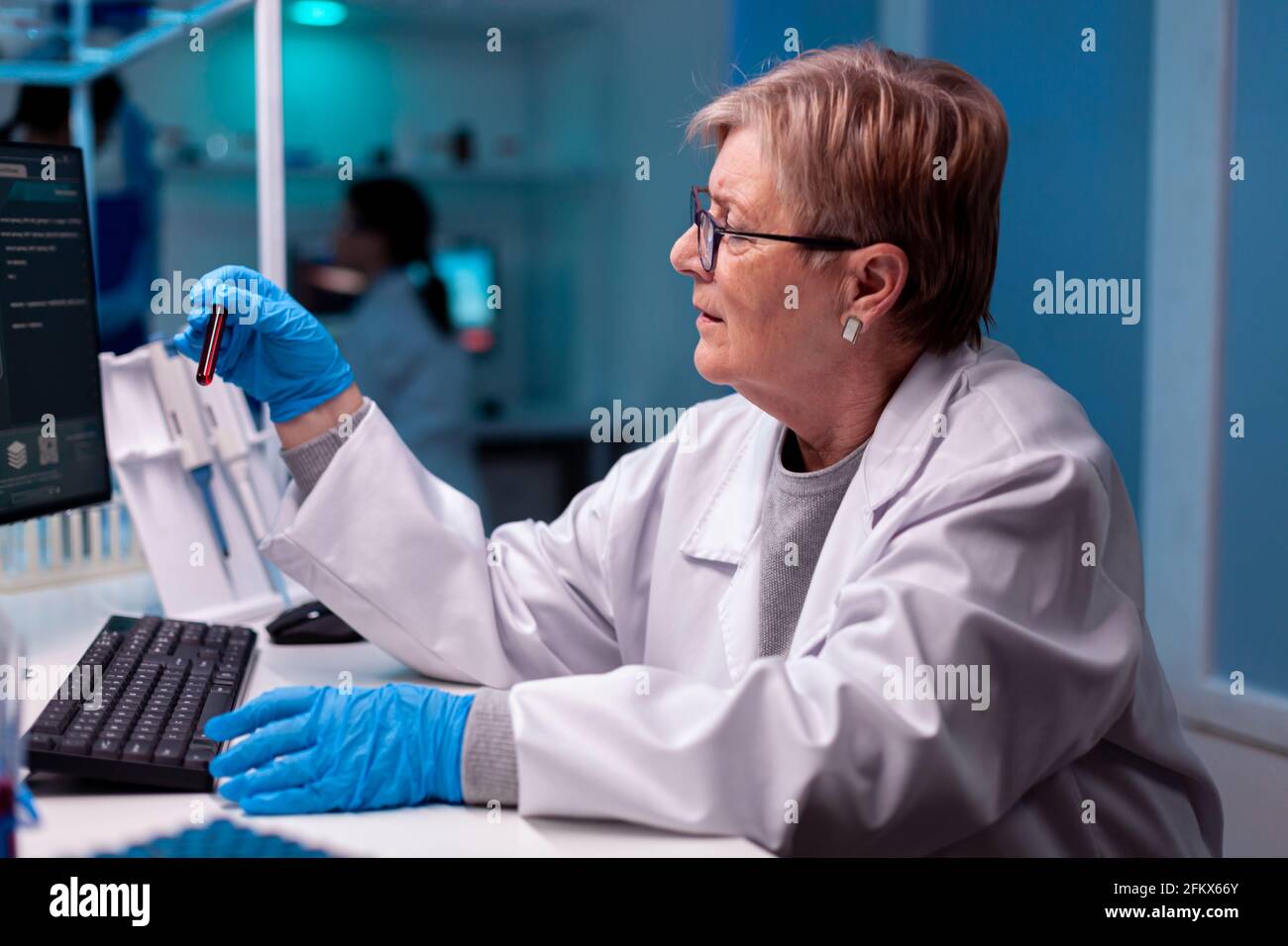 Scientist analysing blood test sample in medical facility hospital ...