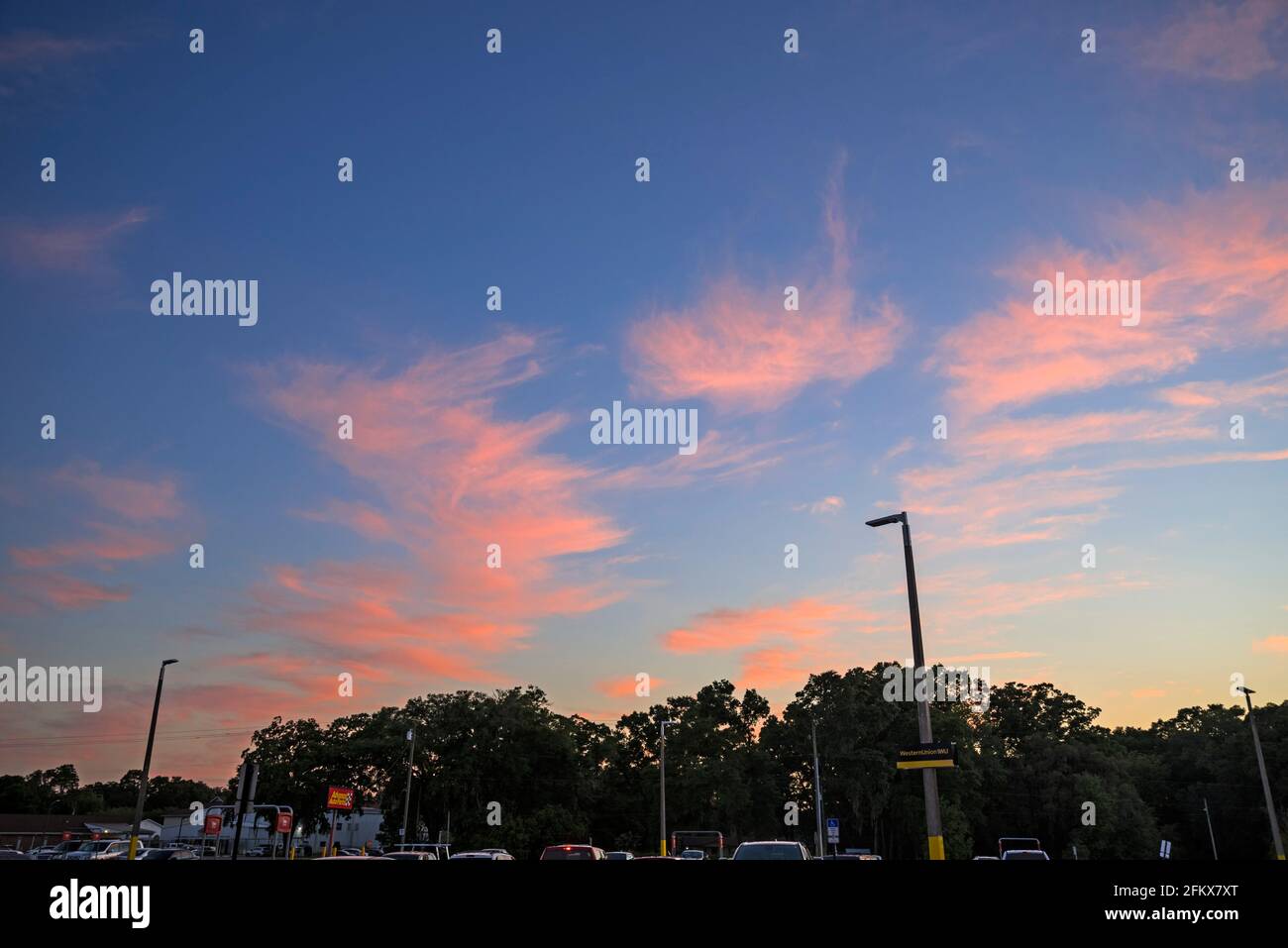 Colorful sunset clouds over a shopping center in High Springs, Florida ...