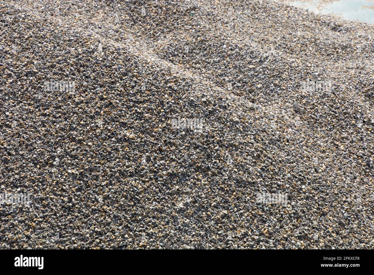 building material background with a heap of different colored small ...